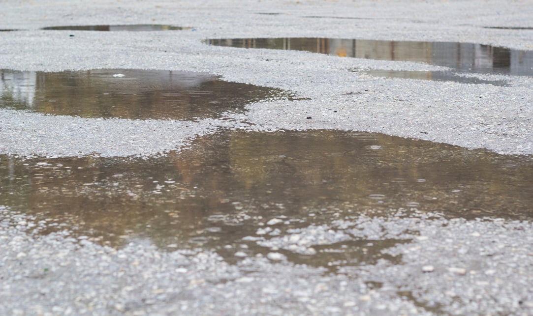 What Is Causing Puddles To Form In My Parking Lot Asphalt Paving Expert Qa